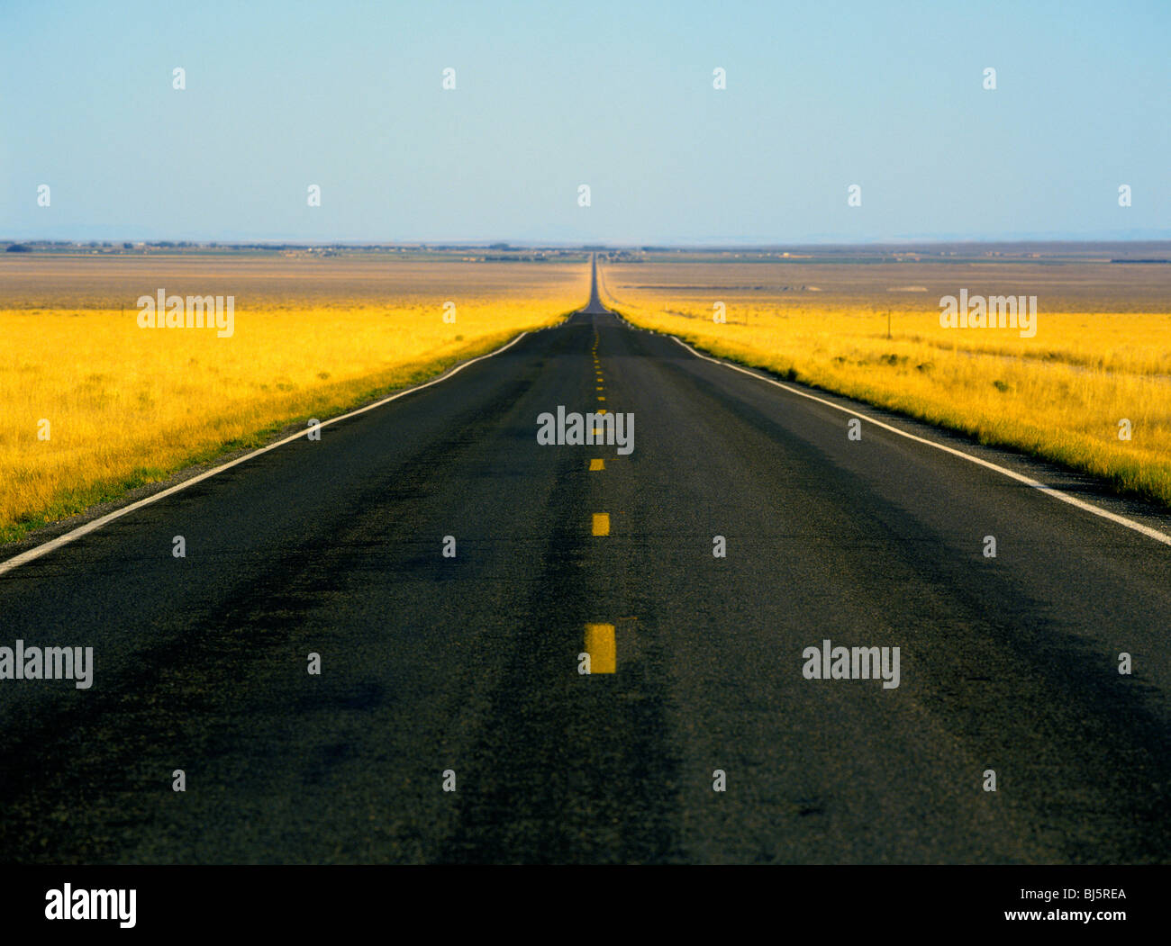 Highway 28, a two lane highway, receding to the distant horizon, near ...