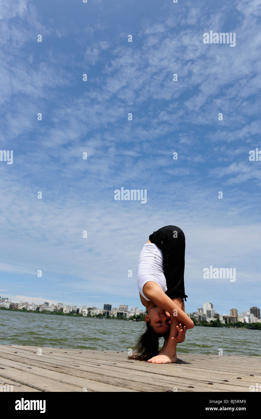 Flexible woman stretching, bending over outdoors Stock Photo - Alamy