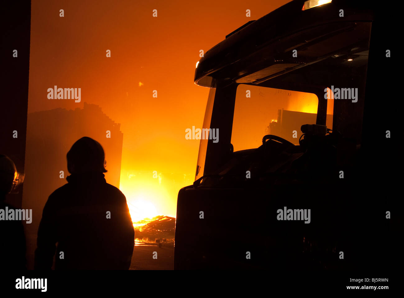 Fireman and fire engine silhouetted against flames FULLY MODEL RELEASED ...