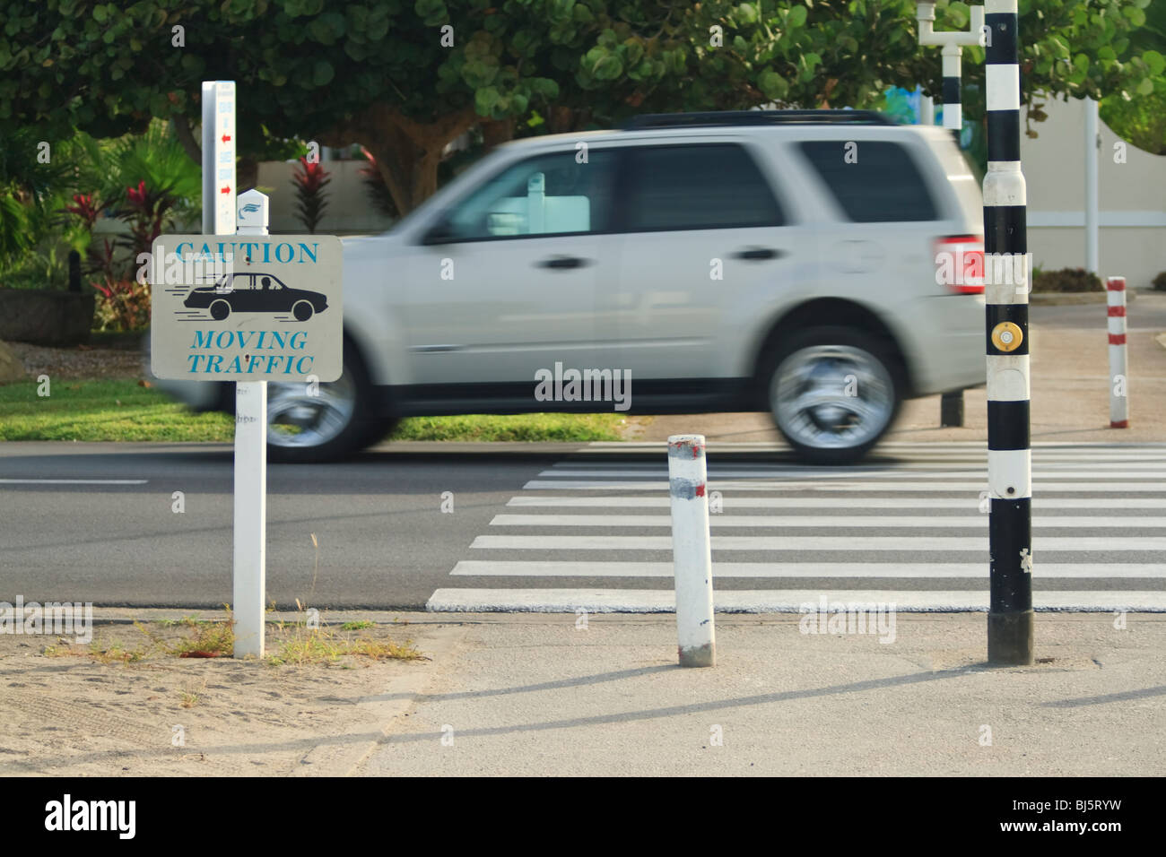 caution moving traffic sign with suv speeding by Stock Photo - Alamy