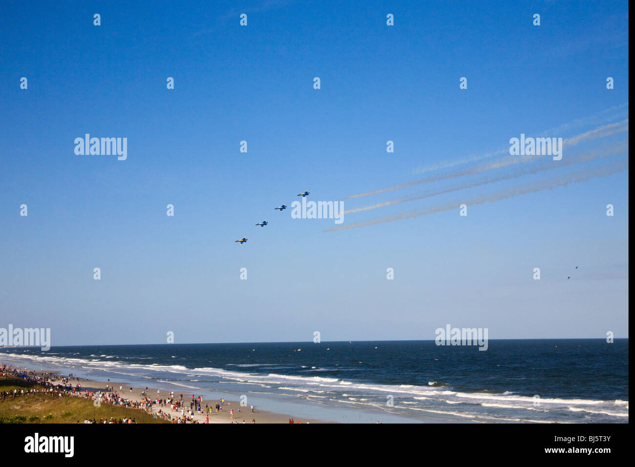 Four US Navy Blue Angels flying over the Atlantic Ocean at an air show ...