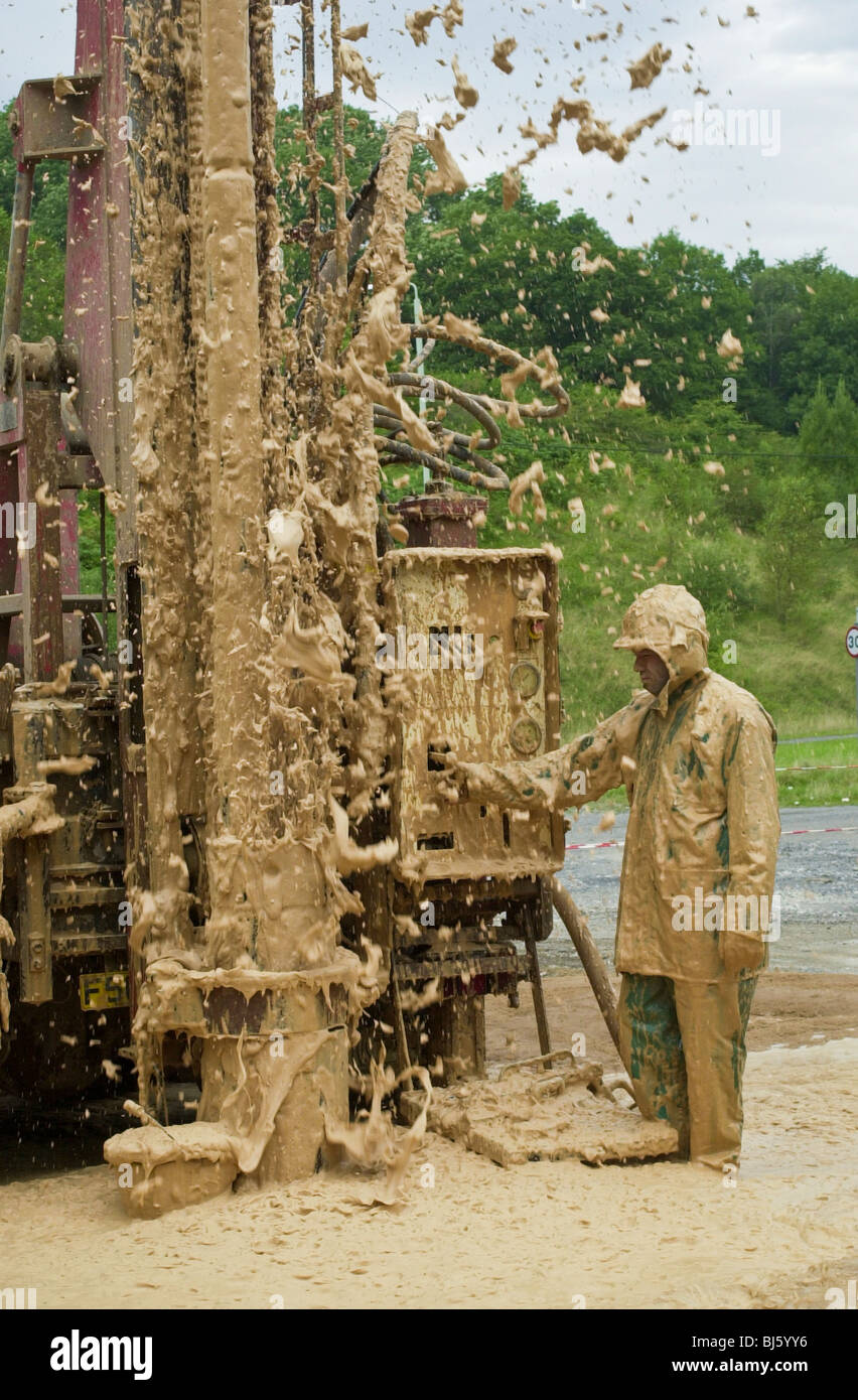 Engineer covered in foam and mud while drilling for water at Gwalia ...