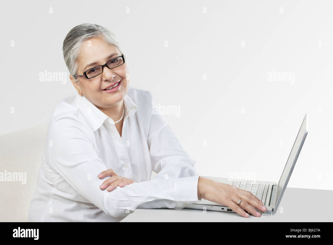 Old indian lady happy laptop hi-res stock photography and images - Alamy