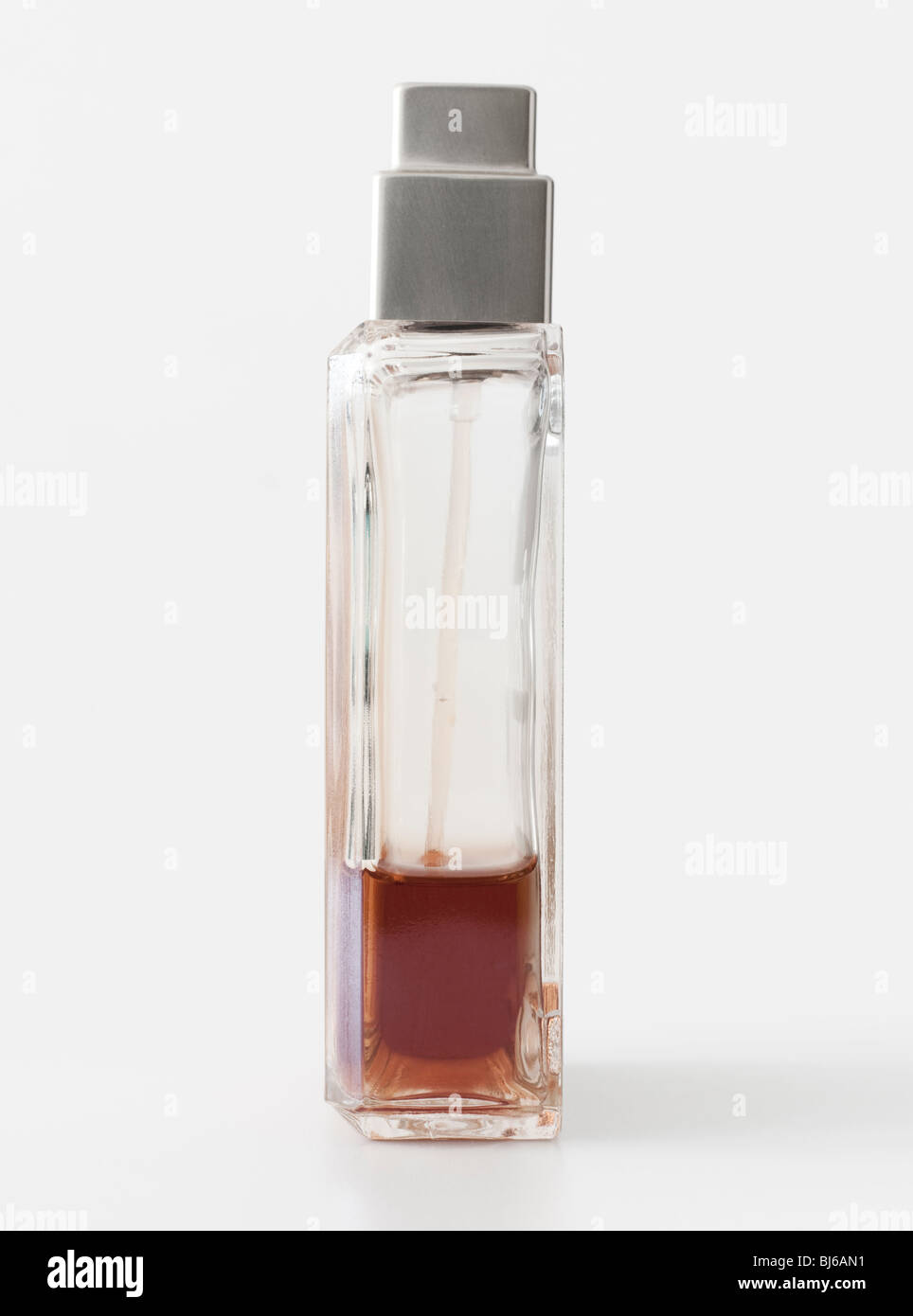 almost empty perfume bottle over a white background Stock Photo - Alamy