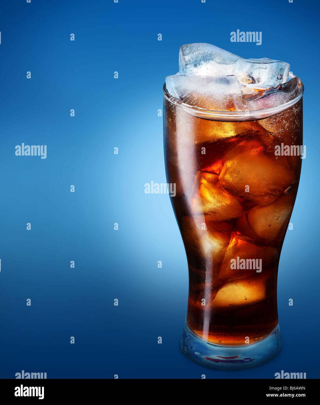 Glass of cola with ice on a blue background Stock Photo - Alamy