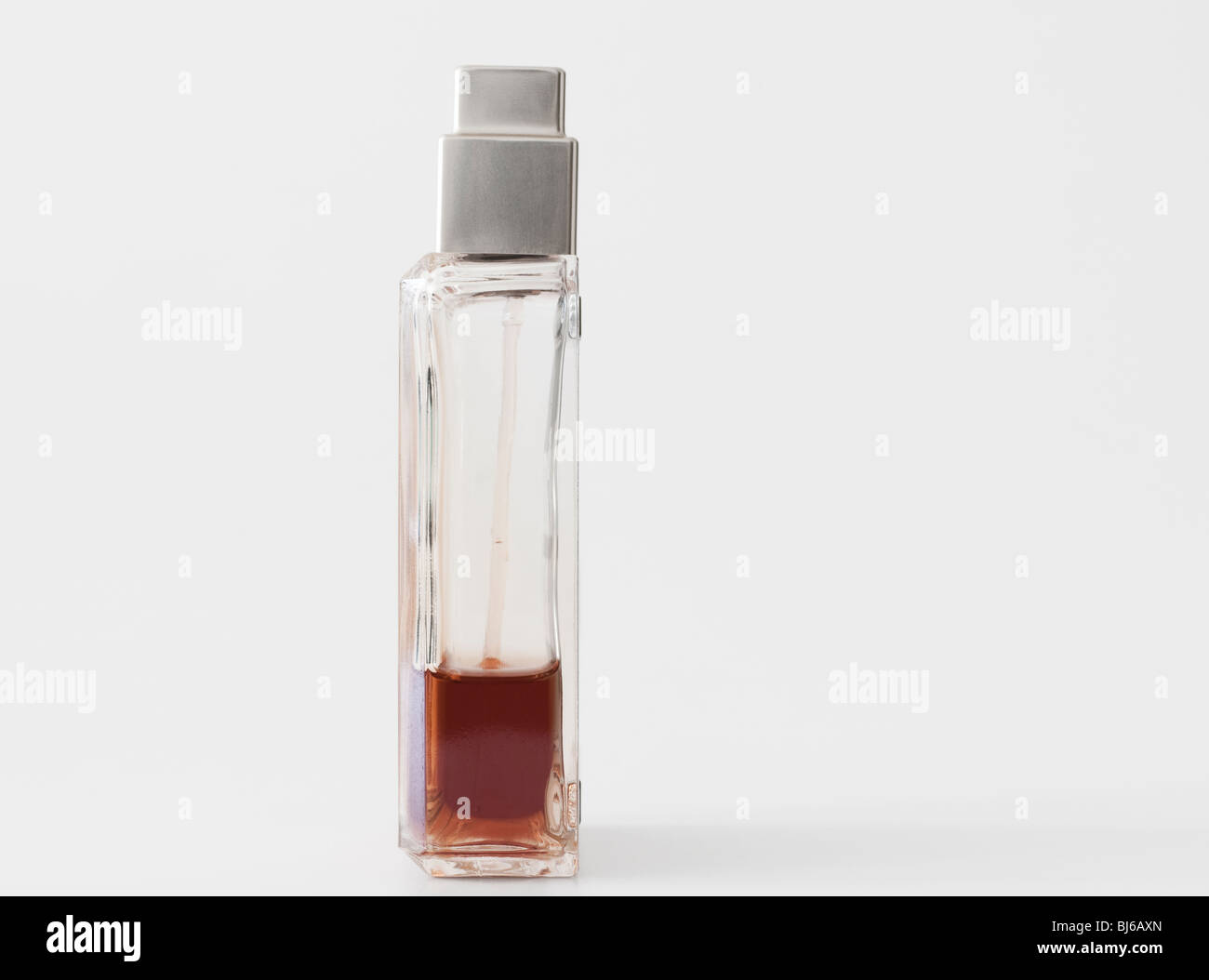 almost empty perfume bottle over a white background Stock Photo - Alamy