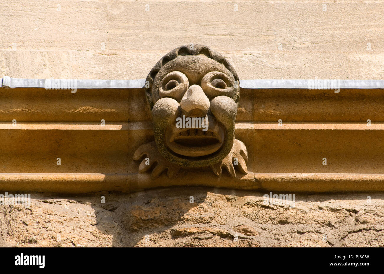 a comic gargoyle with a fat face on a college wall in Oxford UK (New ...