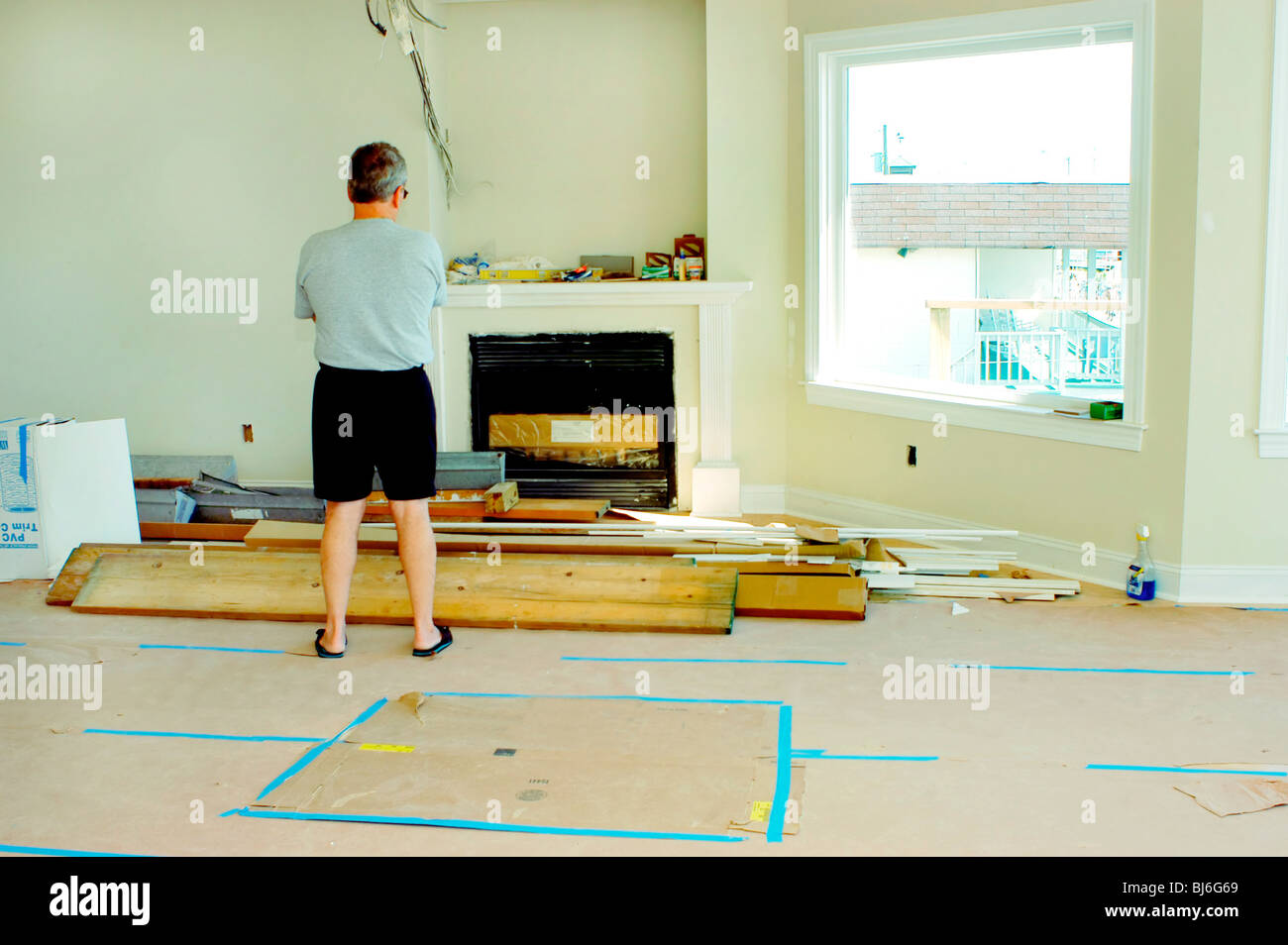 Male Owner of Condominium, Man Standing inside from Behind, Looking at ...