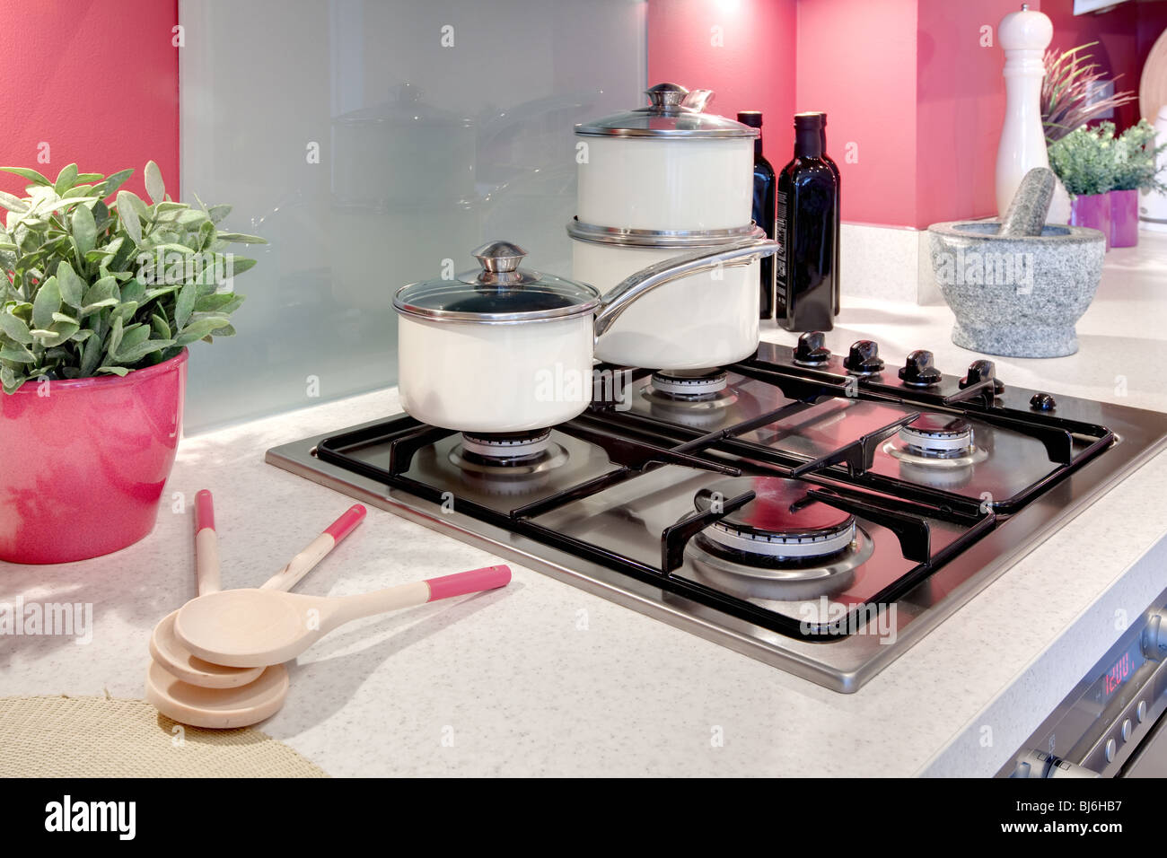 modern kitchen hob with pans and utensils Stock Photo - Alamy
