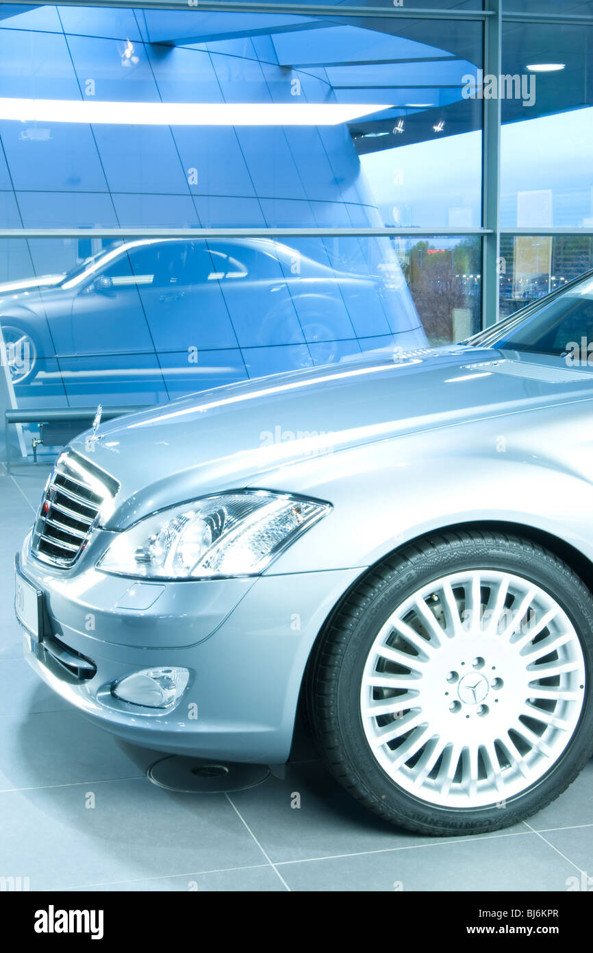 Front, side view of a luxury car and his reflection in glass, Mercedes ...