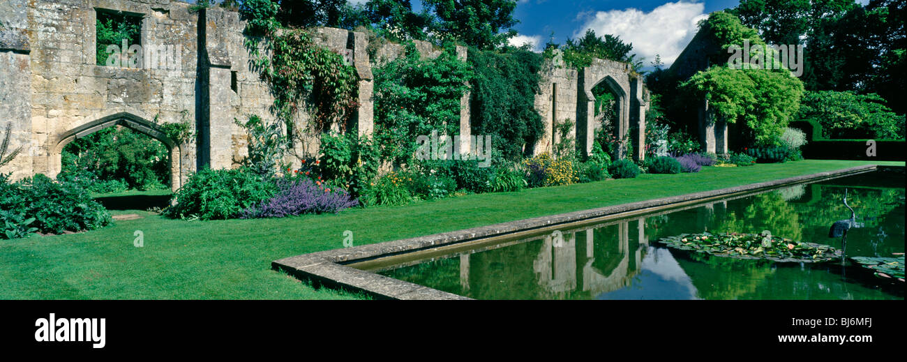 The 16th century Tithe Barn and ornamental pond in the grounds of ...