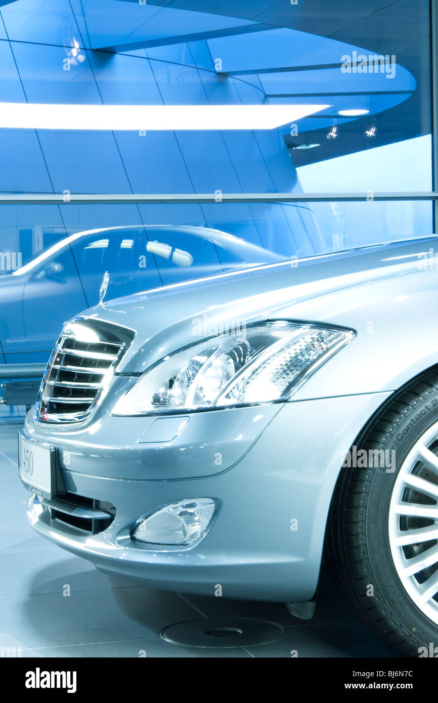 Front, side view of a luxury car and his reflection in glass, Mercedes ...