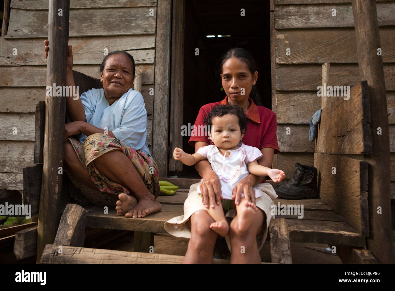 Indonesia, Sulawesi, Buton, Labundo Bundo, three generations sitting on ... Indonesia, Sulawesi, Buton, Labundo Bundo, three generations sitting on ...
