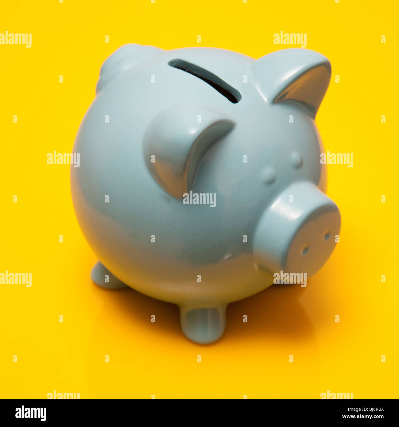 Piggy bank style money box on a yellow studio background Stock Photo ...