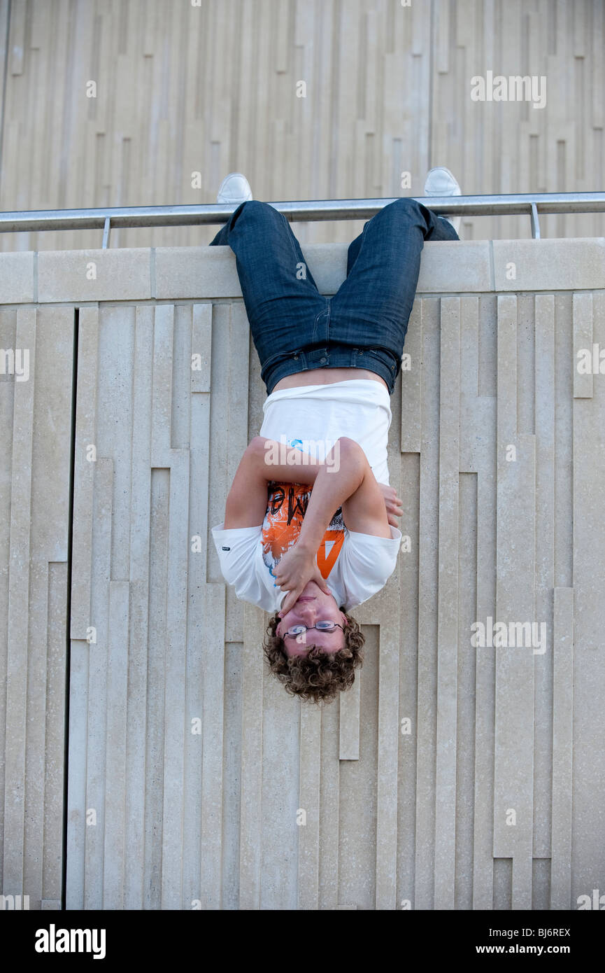 Teenager male hanging upside down Stock Photo - Alamy