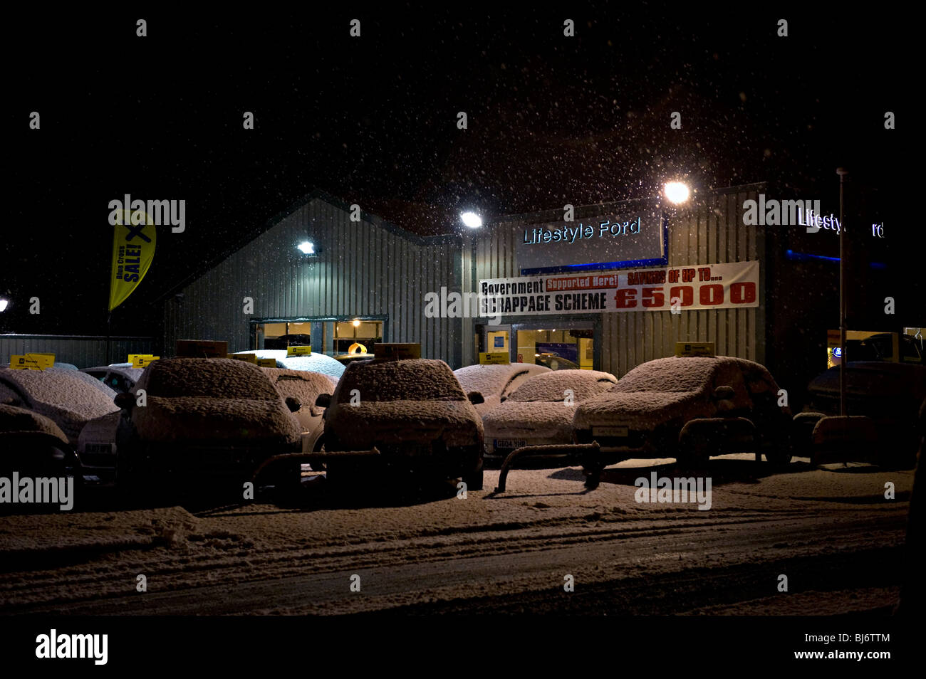 Heavy snow falling at night at road junction Stock Photo - Alamy
