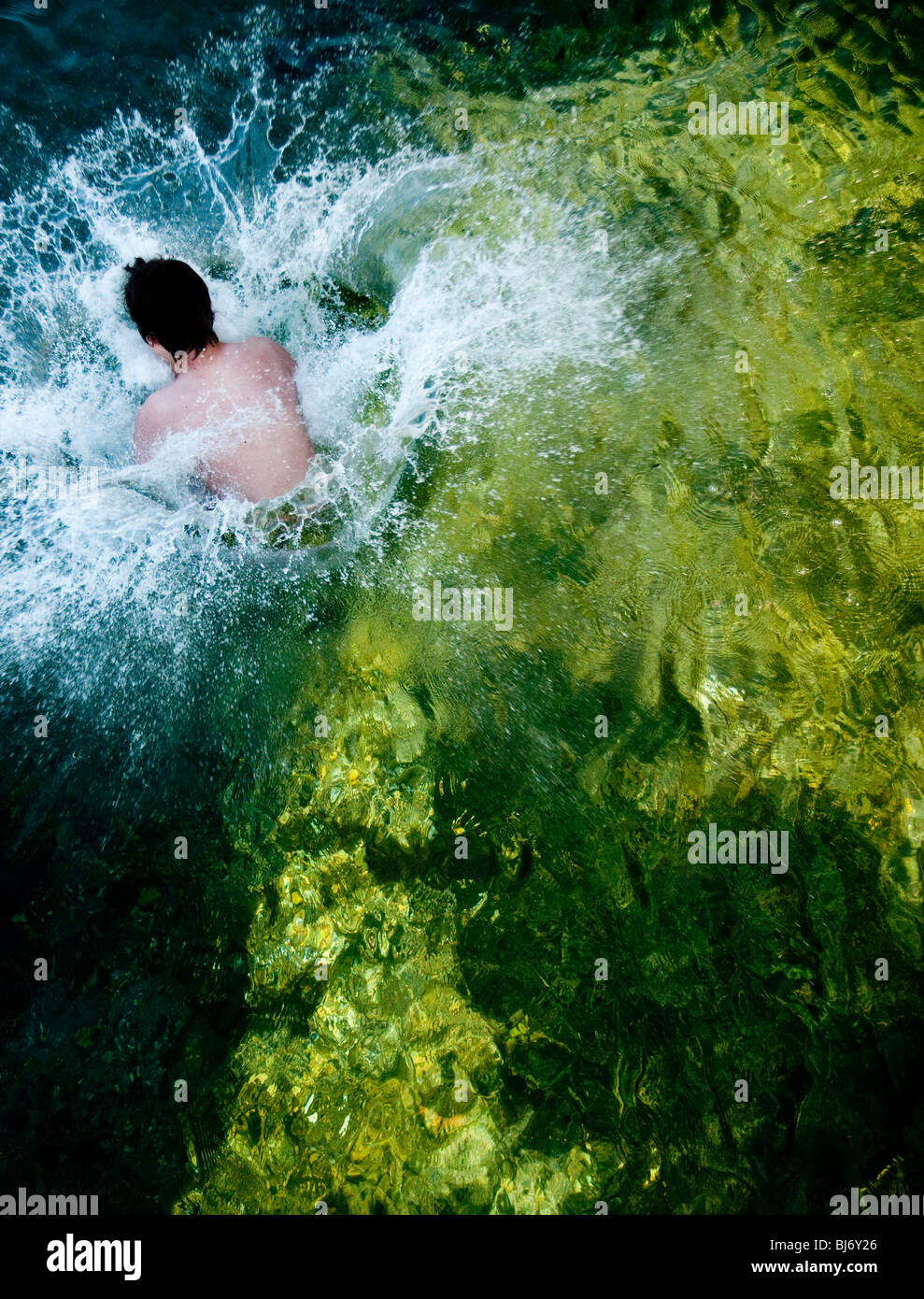 Boy jumping into river Stock Photo - Alamy