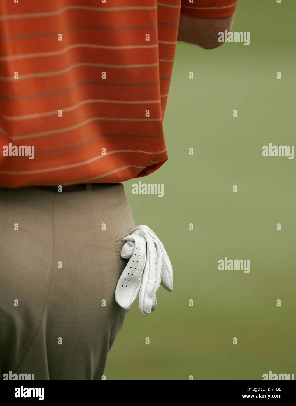 Rear view of man with golf gloves hanging out from back pocket (close ...