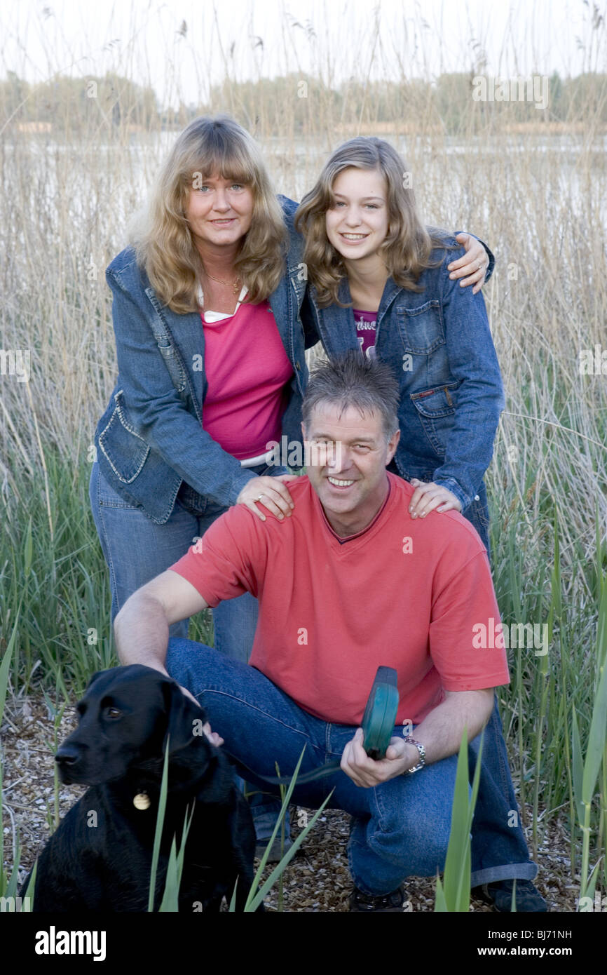 Happy family unit and domestic dog outside in nature, portrait, happy ...
