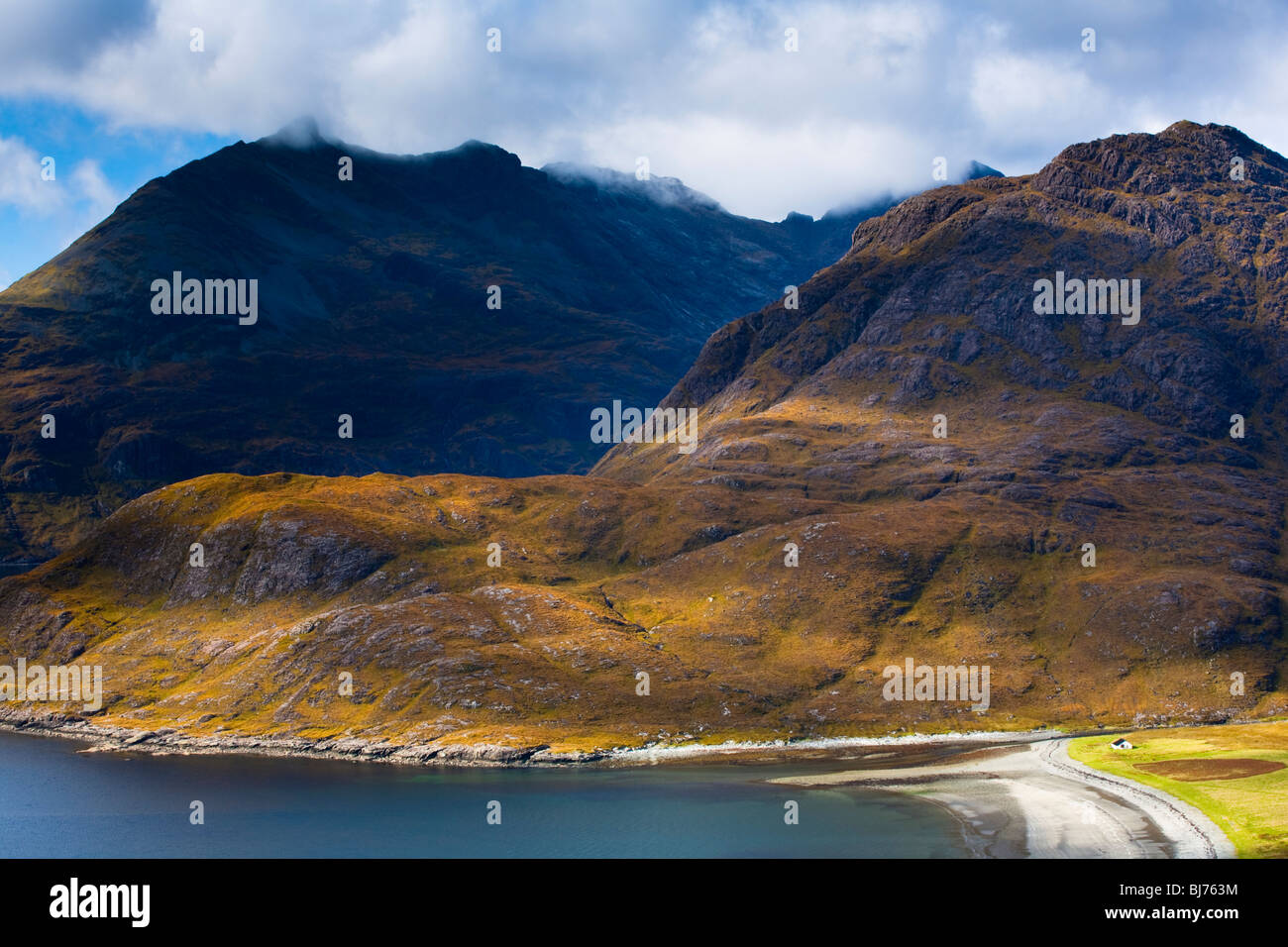 Scotland, Isle of Skye, Loch Scavaig. Breaking light on the lower hills ...