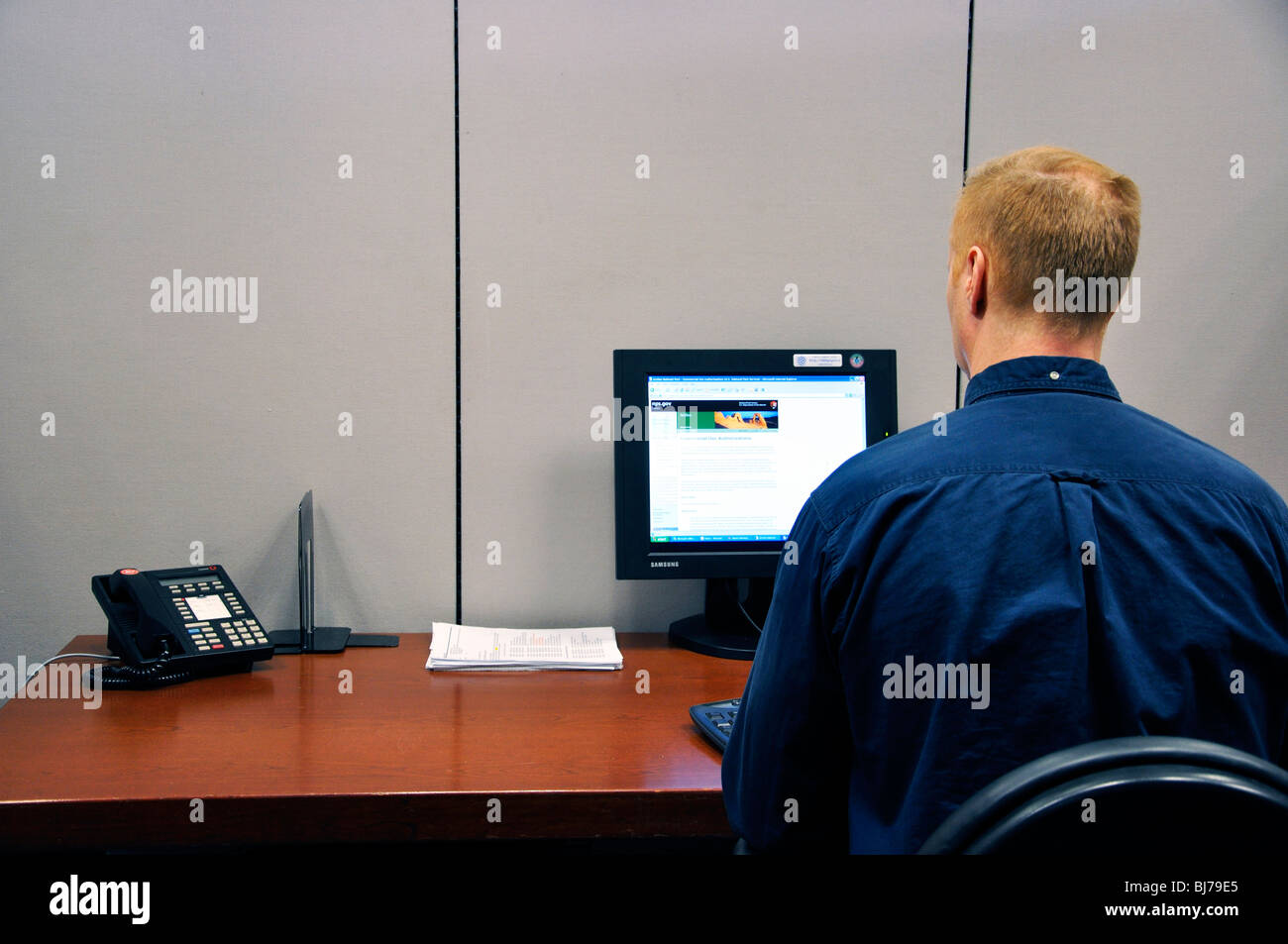 Office worker in his cubicle Stock Photo - Alamy
