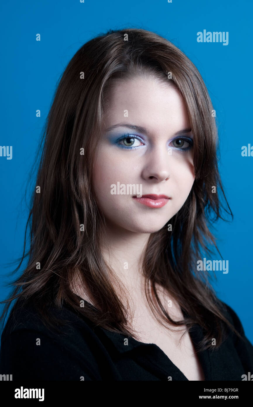 Portrait of teenager head and shoulder portrait with blue background ...