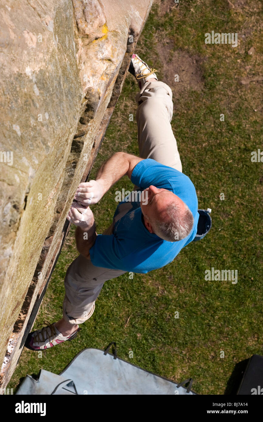 Man bouldering on rocks at Bowden Doors, Northumberland, England Stock ...