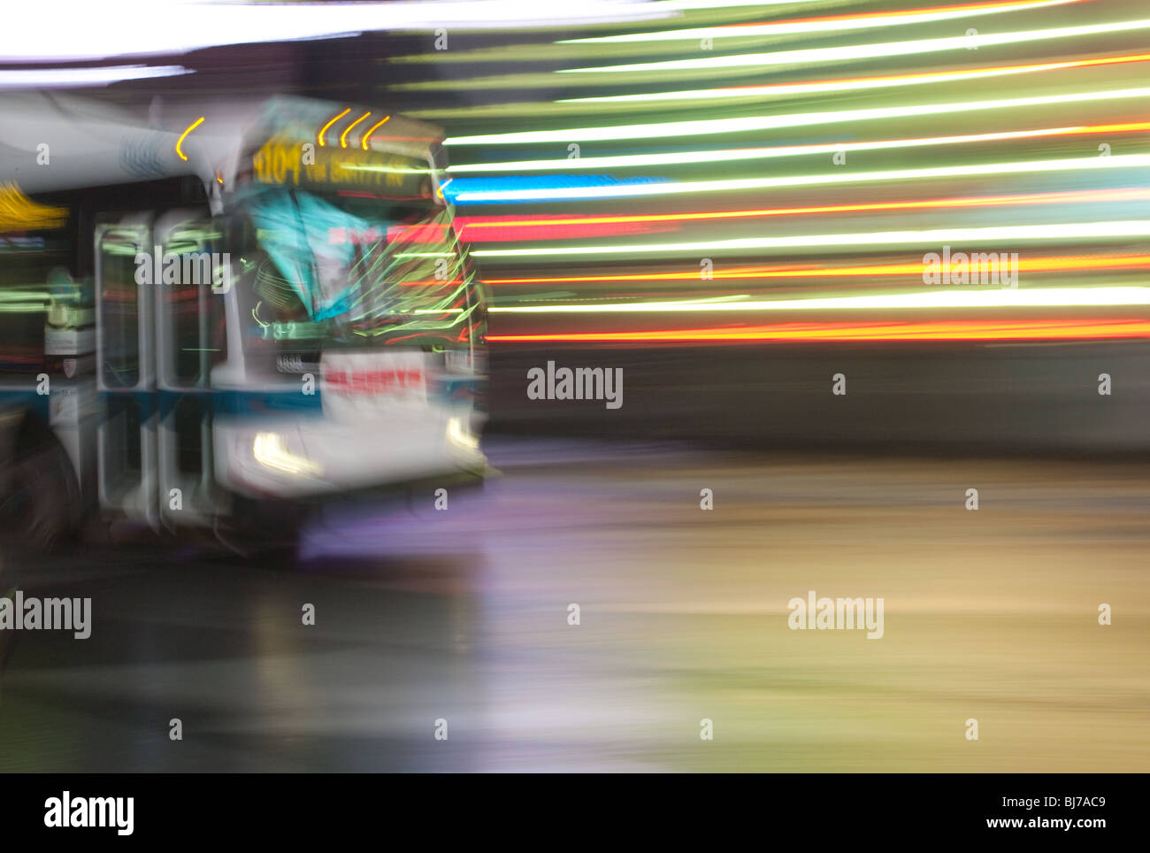 A bus rushed through the lights of Times Square at night in New York ...