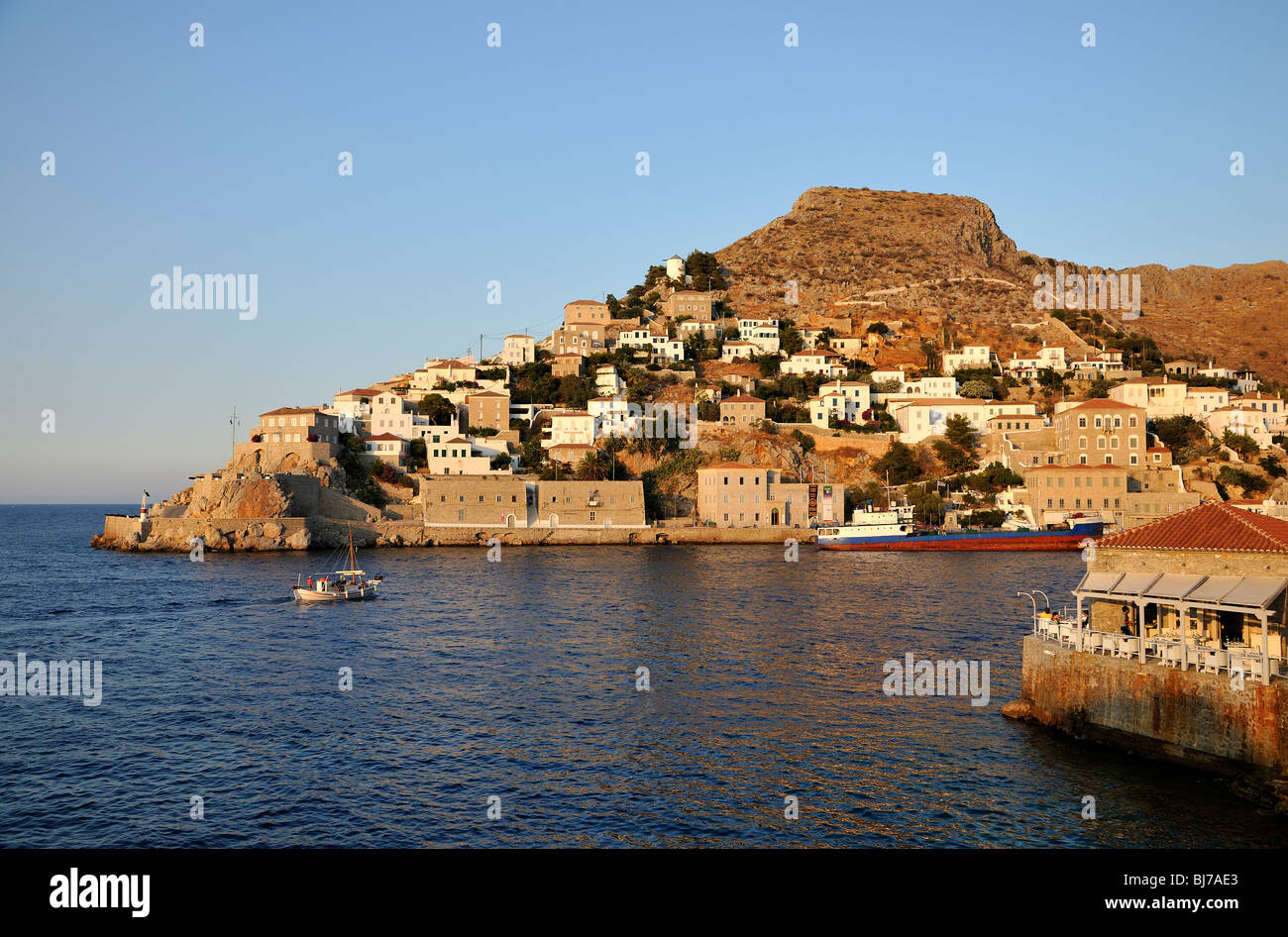 Hydra town taking golden color during sunset, Hydra island, Greece ...