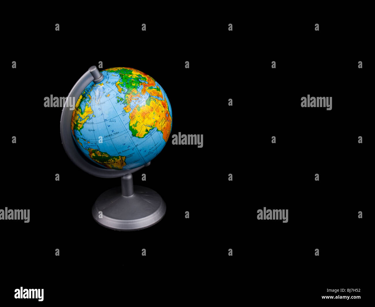 Small globe on black background Stock Photo - Alamy