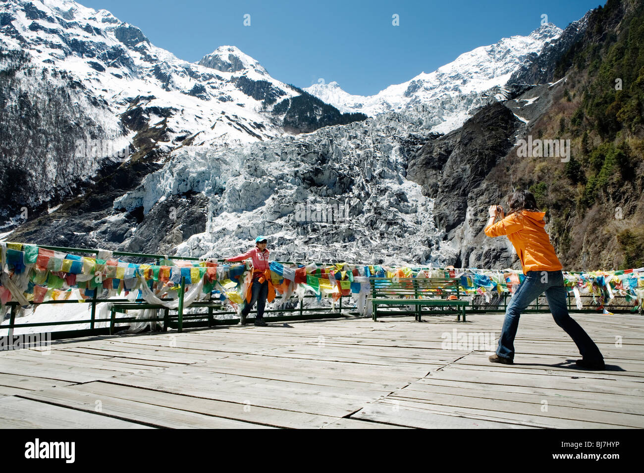 Chinese tourist taking souvenier photos at the holy Mingyong Glacier in ...