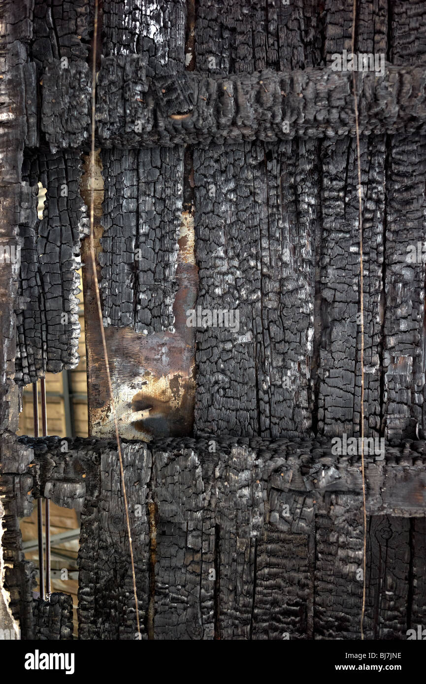 Fire damaged room. Black burnt out wood. Pstel pinted walls. Dramatic ...