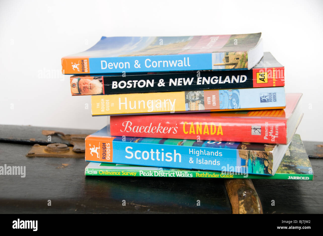 A selection of travel guide books on an old suitcase Stock Photo - Alamy