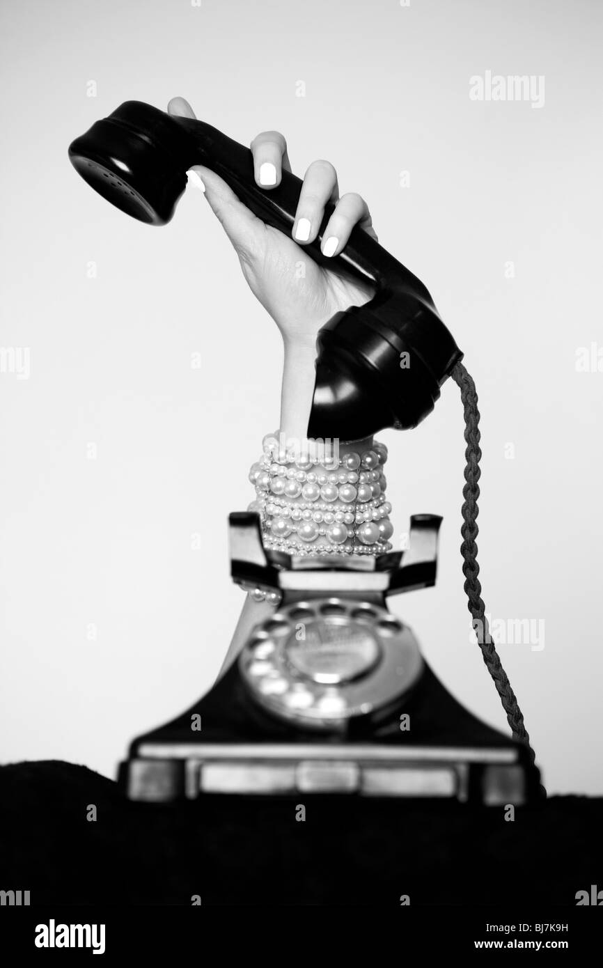 Hand holding landline phone Black and White Stock Photos & Images - Alamy