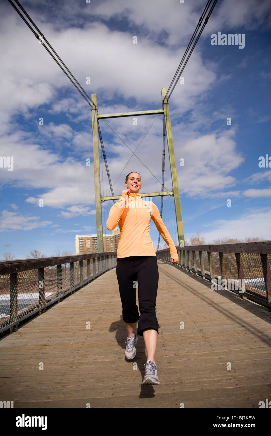 woman running forward on a bridge Stock Photo - Alamy