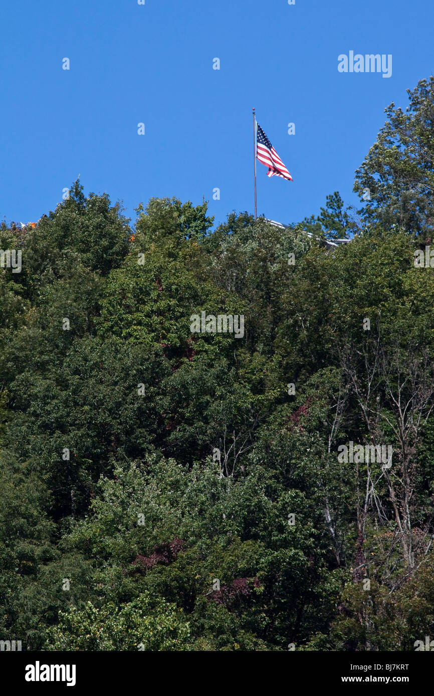 Downtown of city Gatlinburg Tennessee TN the flag on a flagpole against ...