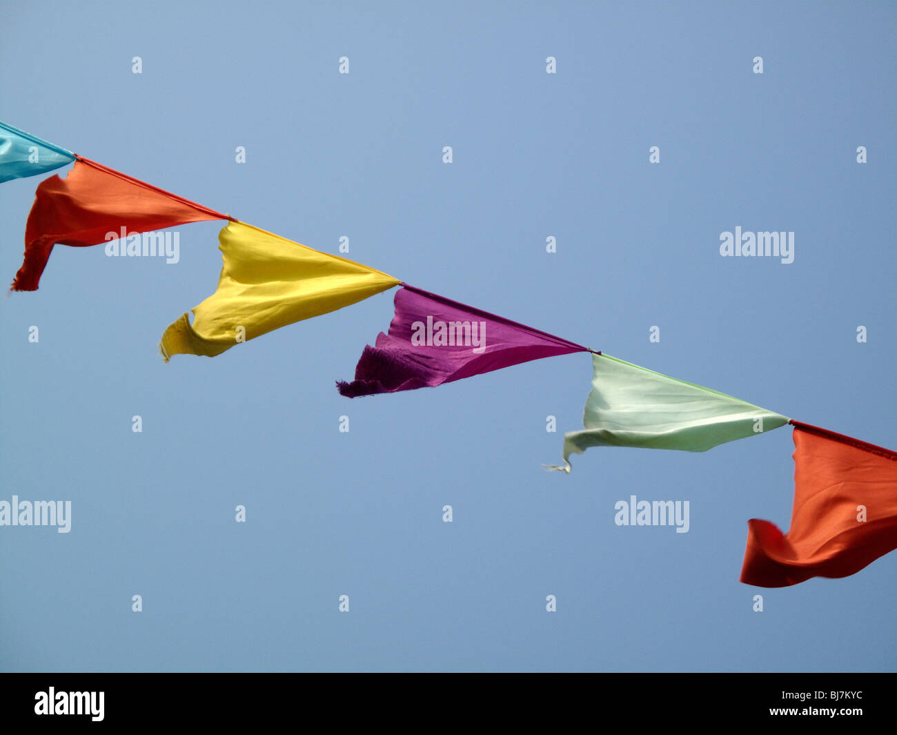 Coloured flags against a blue sky Stock Photo - Alamy
