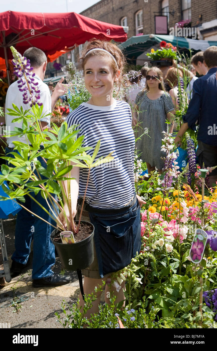 Girl selling flowers at Columbia Road flower market, london, england ...