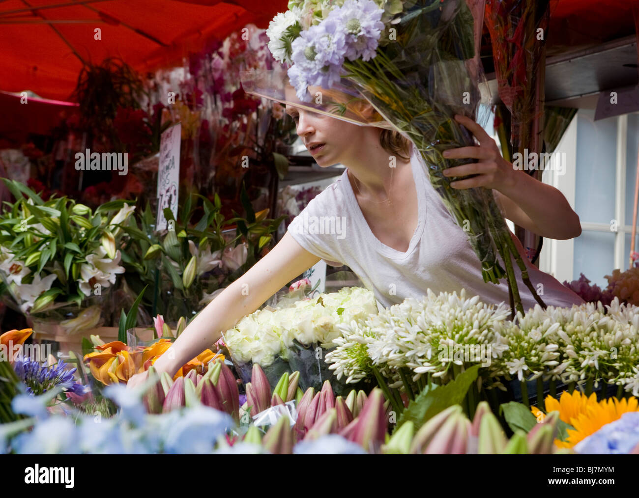 Woman selling flowers at columbia road flower market, london, england ...