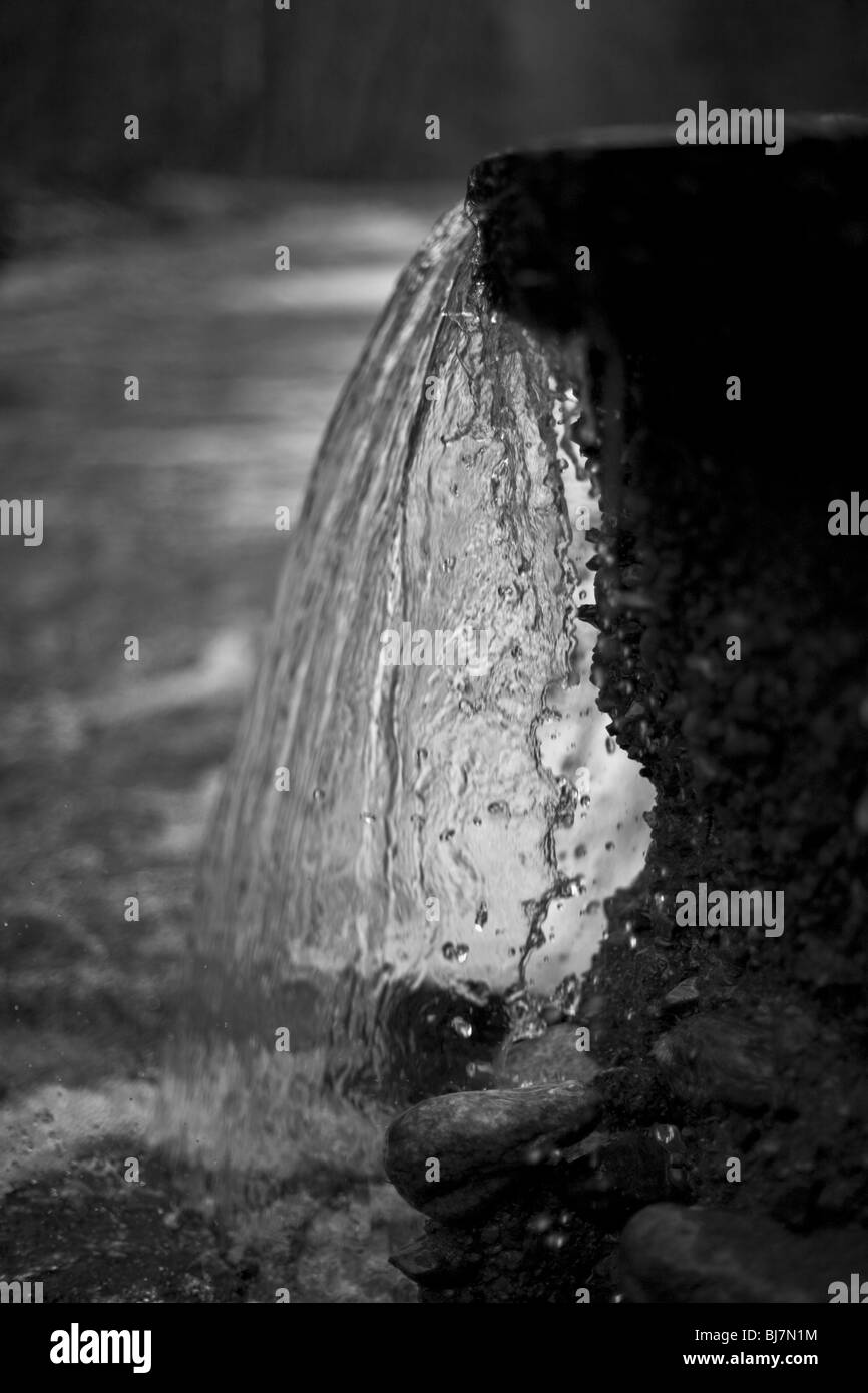 Water falling off flooded roadway Stock Photo - Alamy