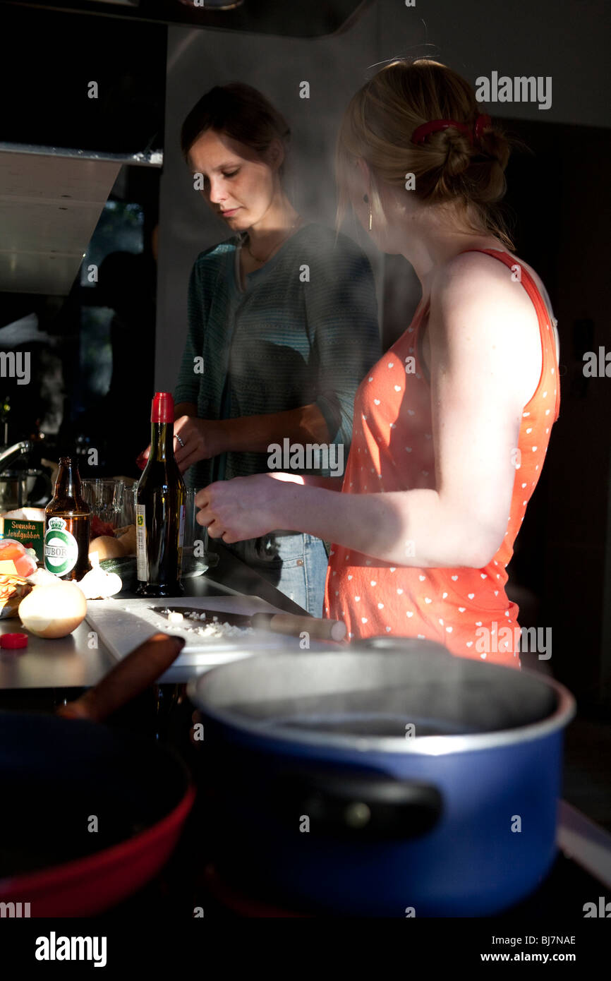 two young women cooking together Stock Photo - Alamy