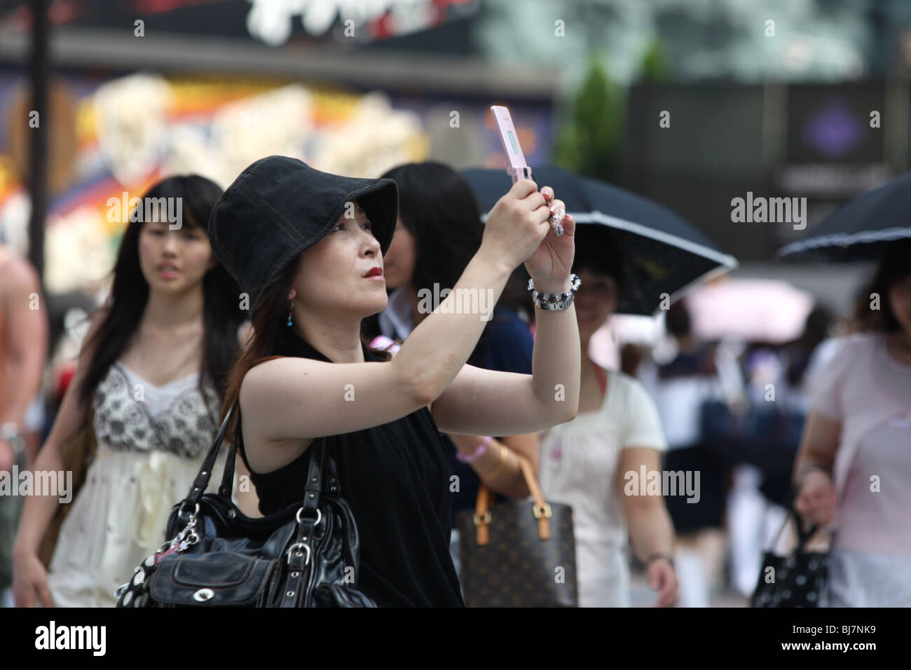 Japanese mobile telephone use by commuters and public in Tokyo, Japan ...