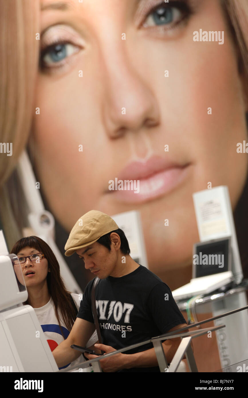 Customers shopping for new mobile telephones in phone store in Tokyo ...
