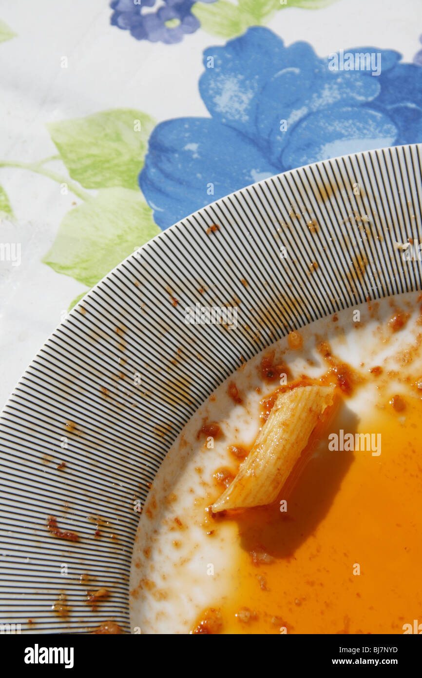 one last pasta quill on plate dish in sun at restaurant Stock Photo - Alamy