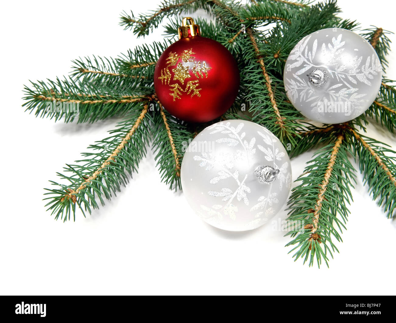 Christmas balls on pine tree branch over white background Stock Photo ...