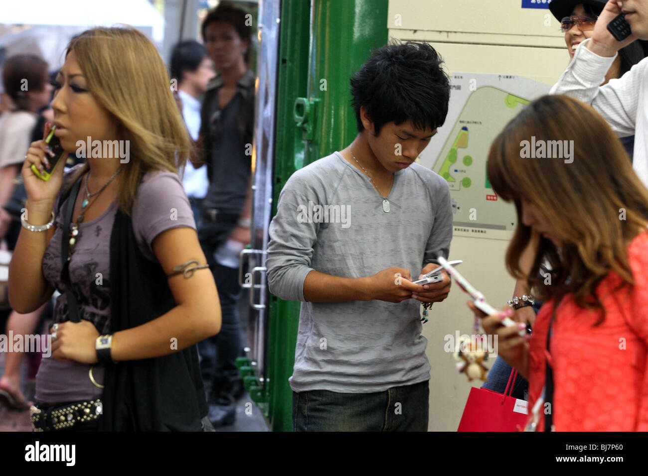Japanese mobile telephone use by commuters and public in Tokyo, Japan ...