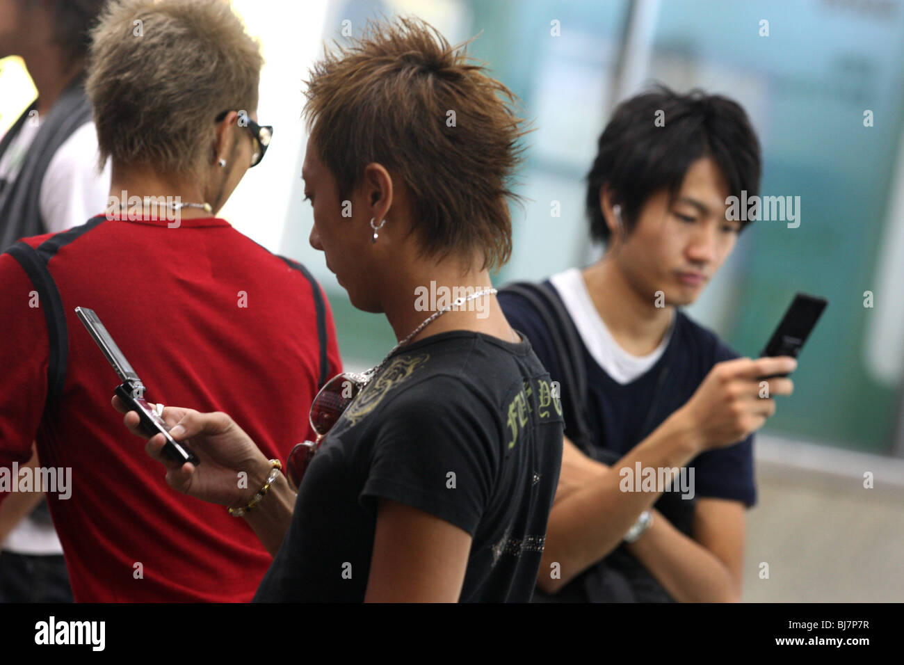 Japanese mobile telephone use by commuters and public in Tokyo, Japan ...