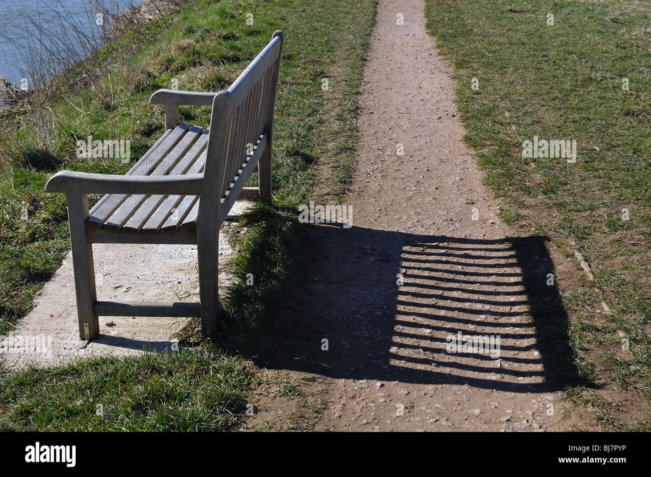 Bench and shadow on path by River Avon, Tewkesbury, Gloucestershire ...