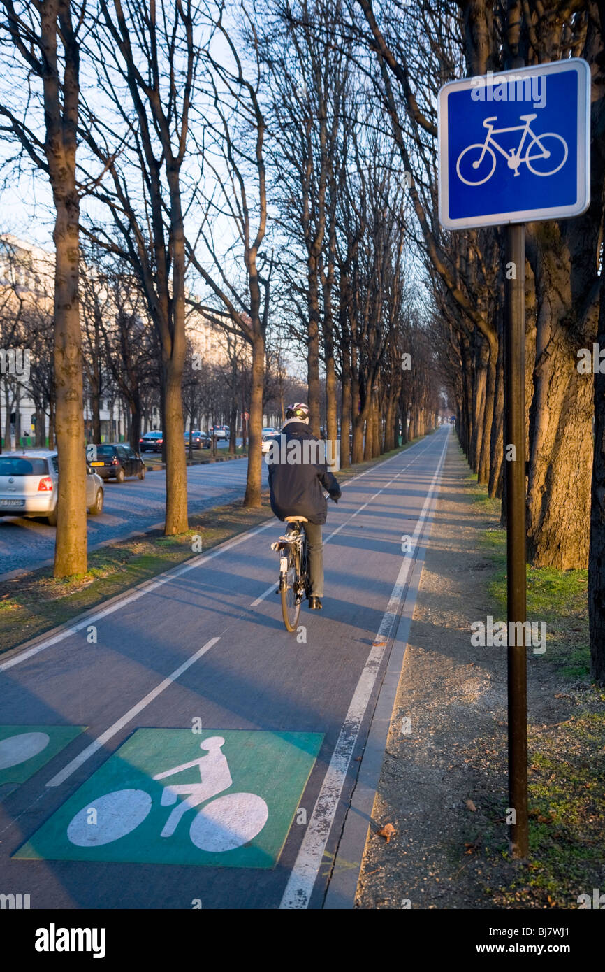 Cyclist cycles along a French bicycle / bike / cycle / lanes / lane in ...