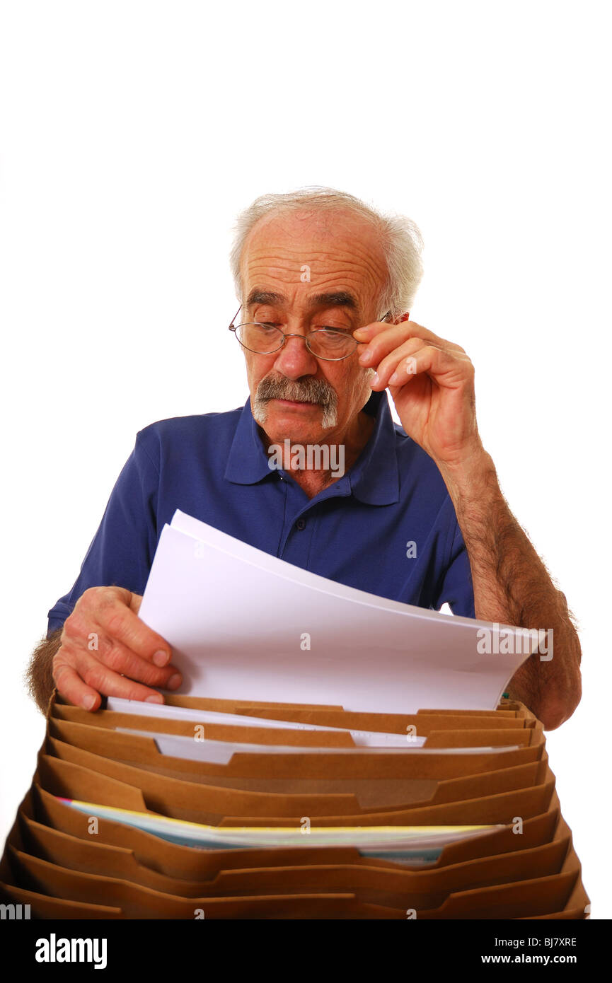 Elderly man looking through paperwork Stock Photo - Alamy